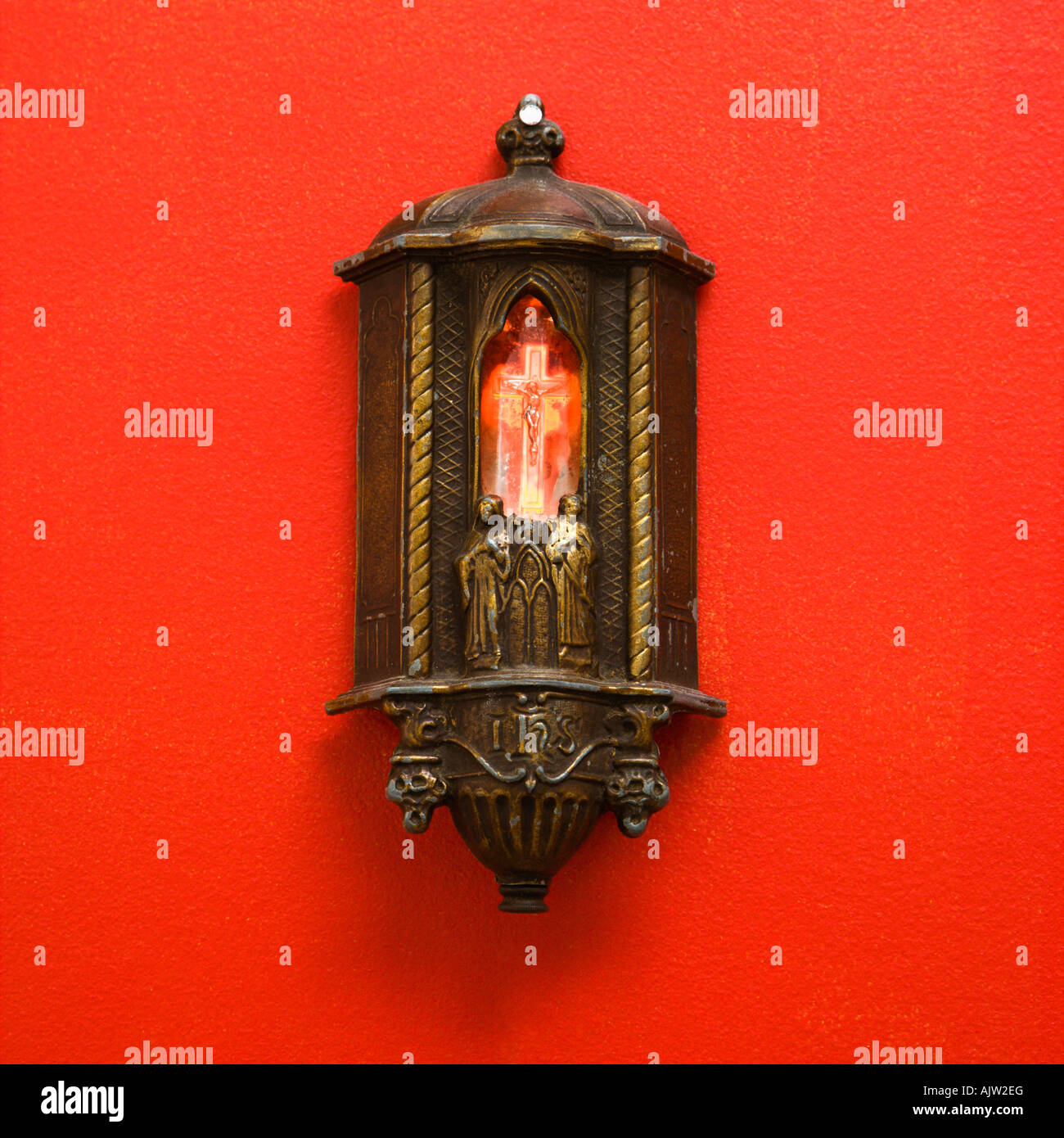 Religious light on red wall with illuminated Crucifixion of Jesus on ...
