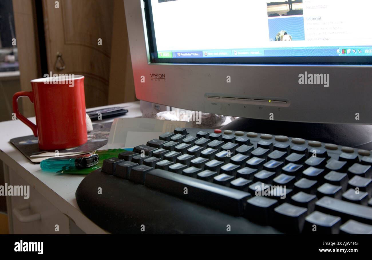 A cluttered desk with PC Stock Photo - Alamy