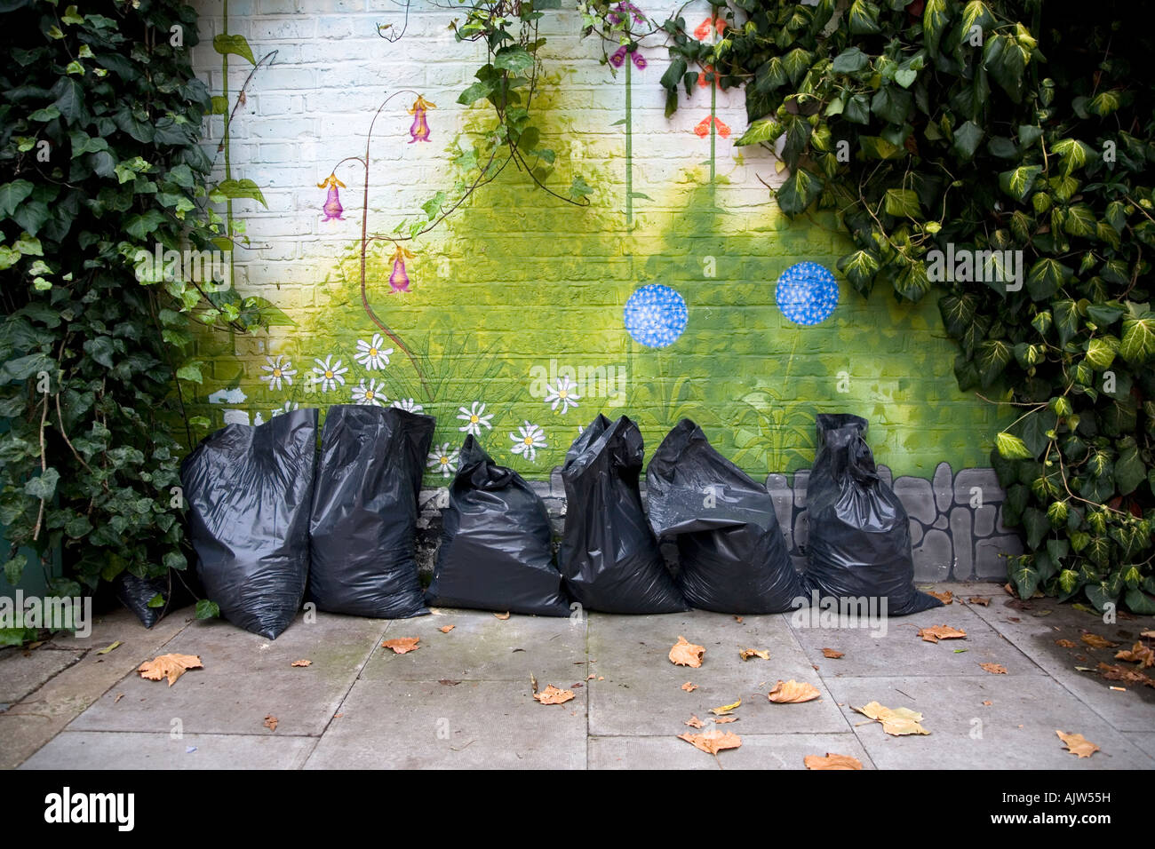 black waste bags awaiting collection placed outside an ornate painted ...