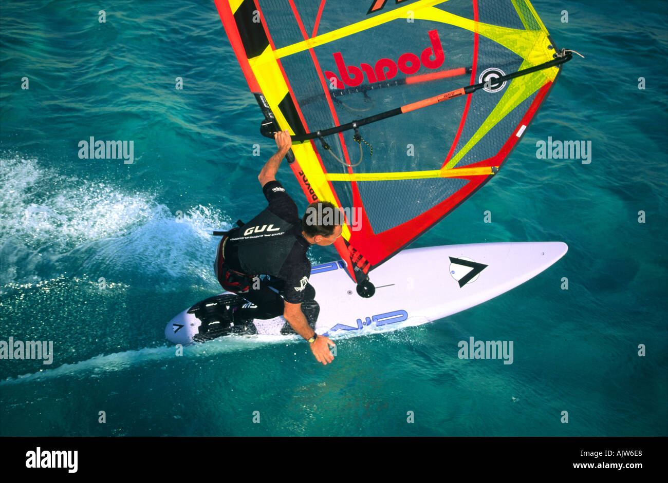 single male windsurfer gybe turning on Red Sea at Ras Sudr Sinai Egypt ...