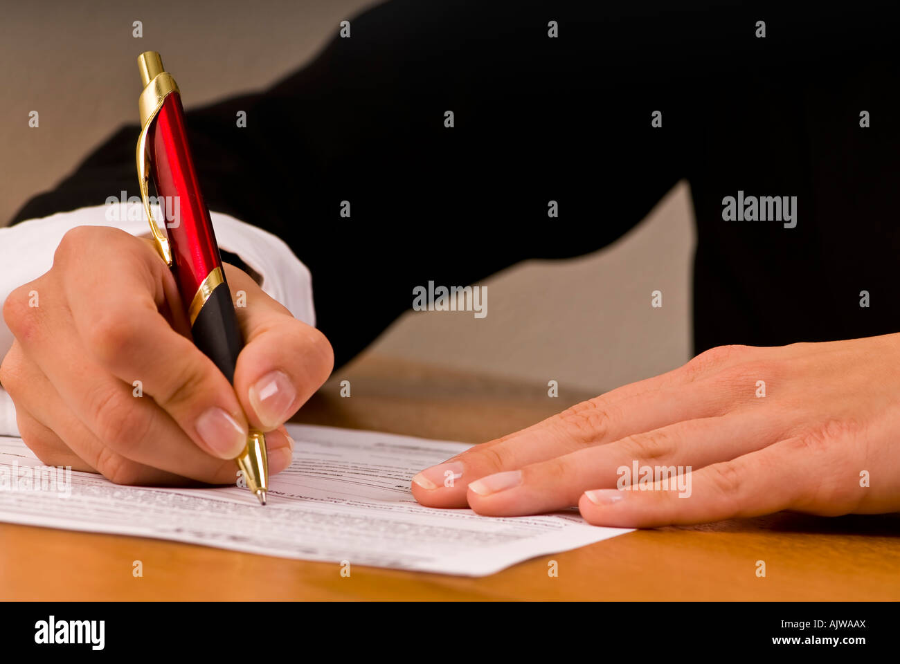Female signing a form Stock Photo - Alamy