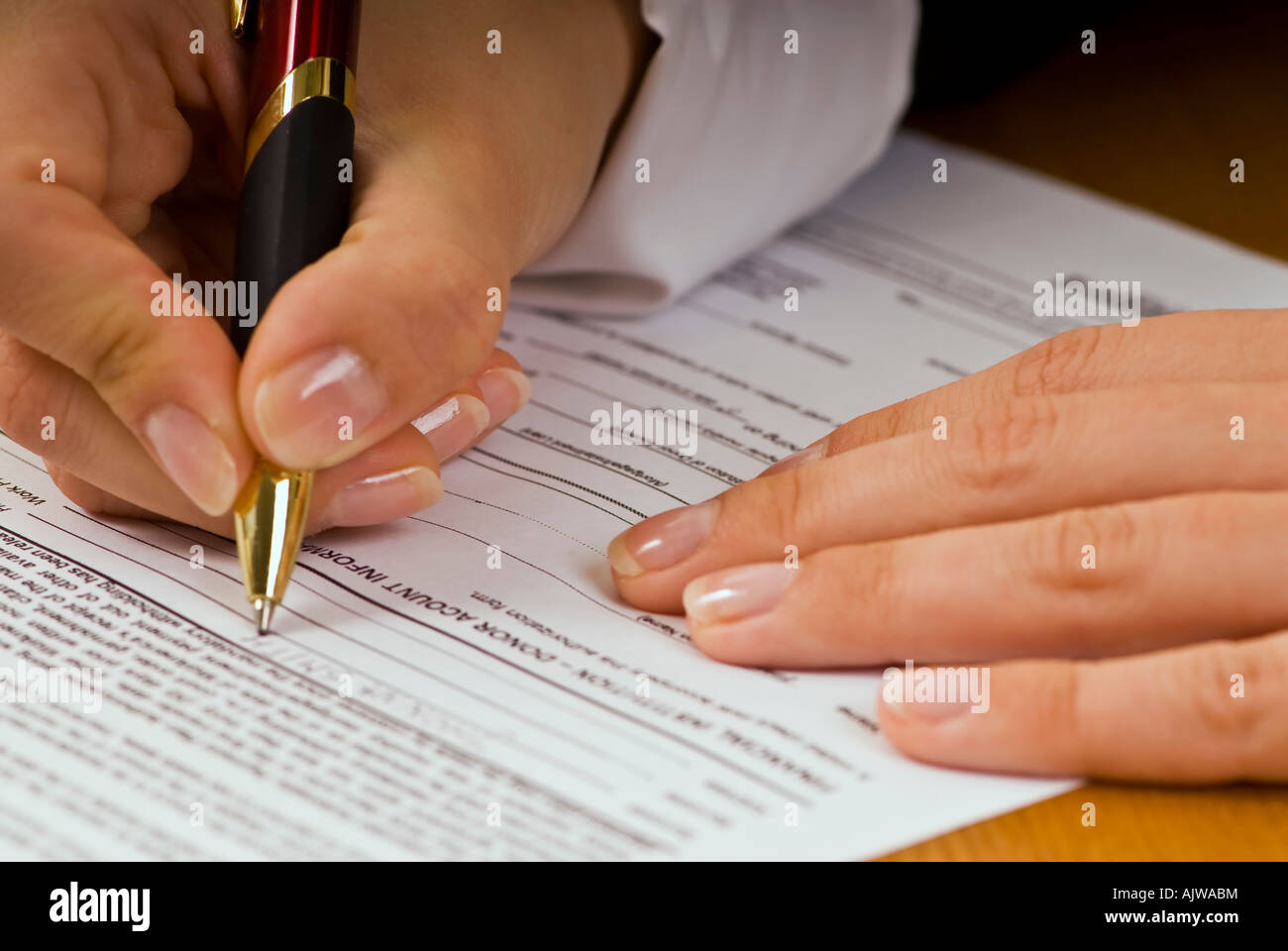 Female signing a form Stock Photo - Alamy
