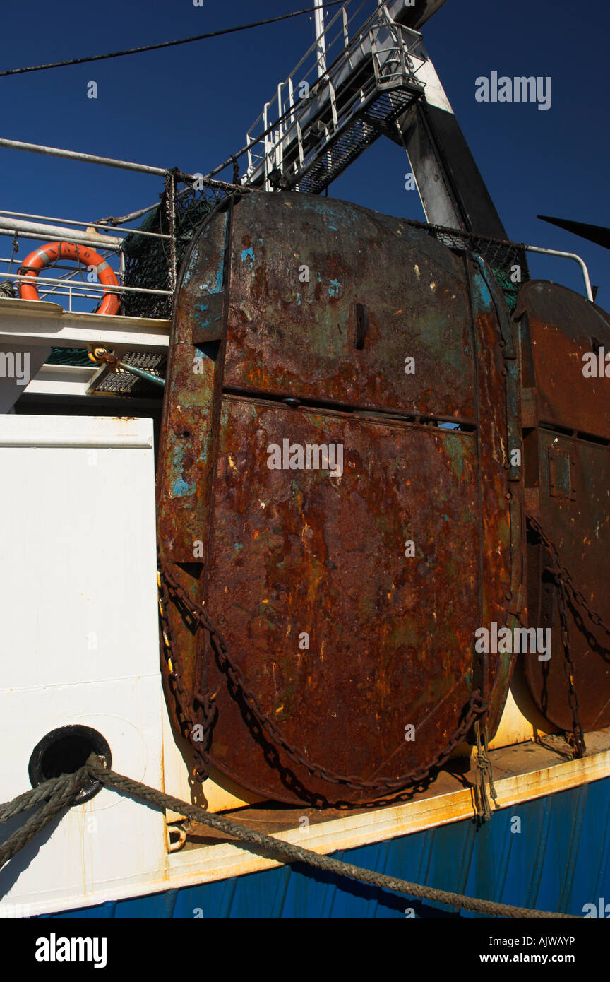 Steel plates hanging on side of vessel used by fishing trawler to drag ...