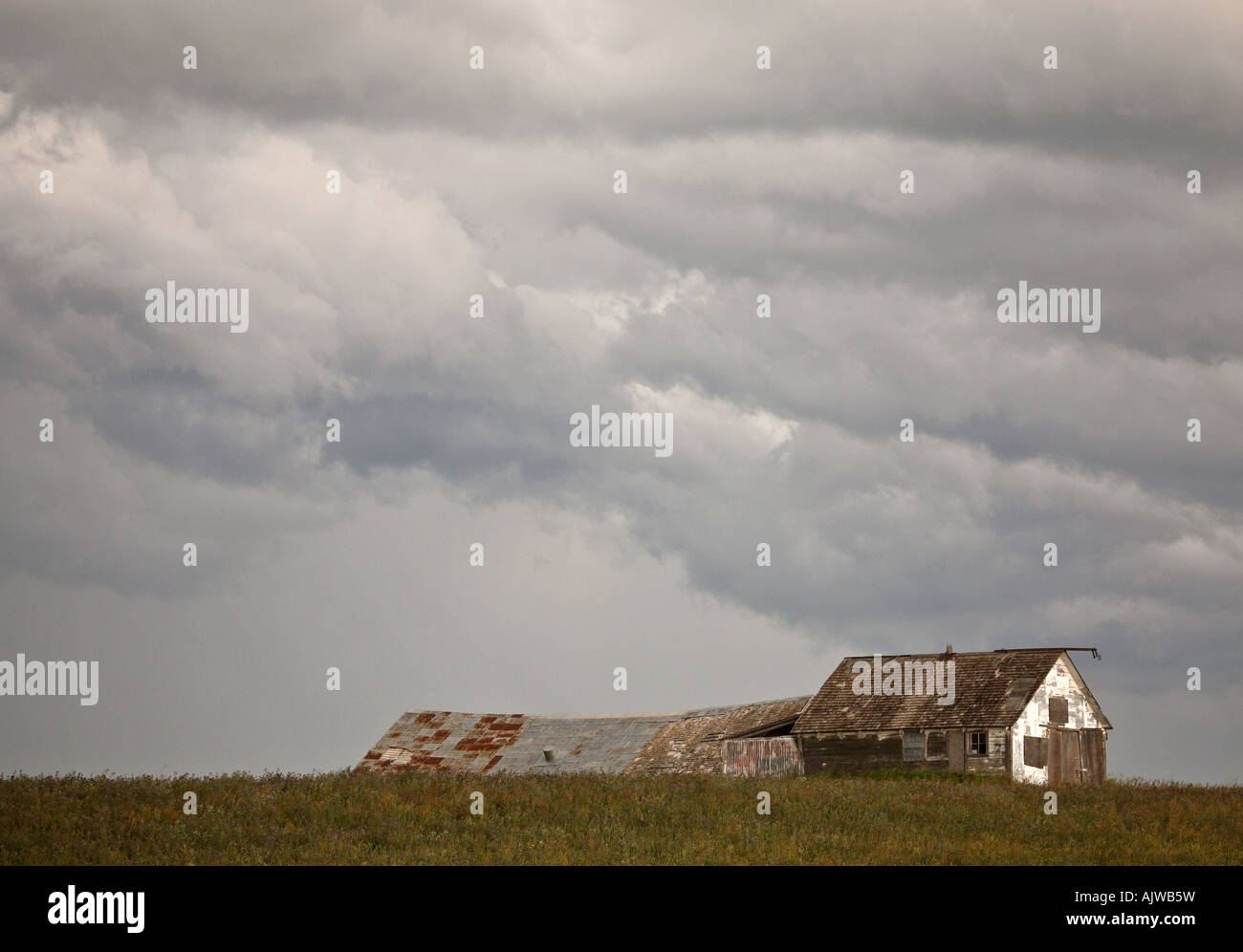 Storm clouds over abandoned farmyard Stock Photo - Alamy
