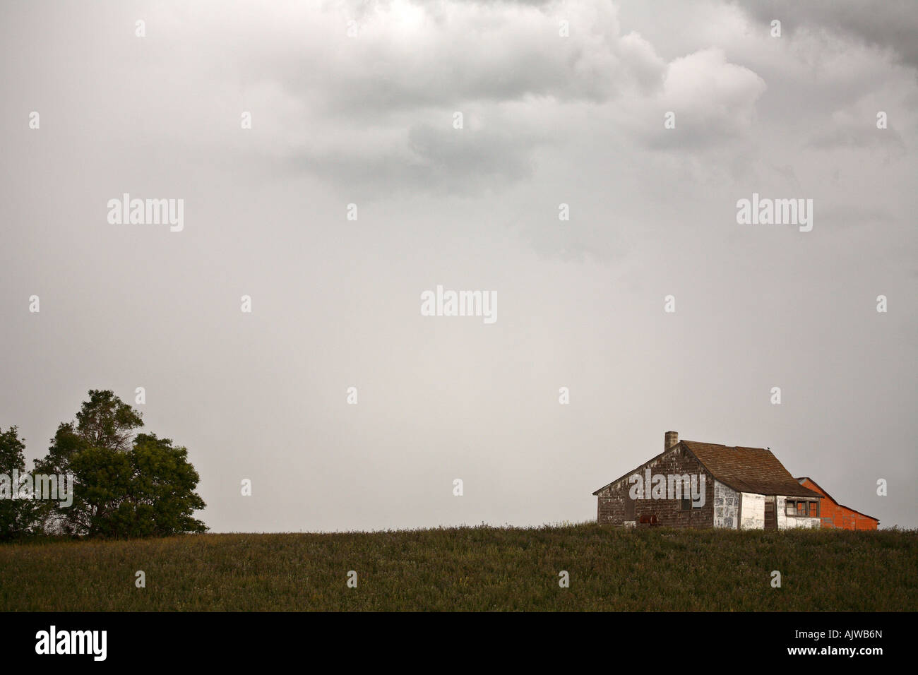 Storm clouds forming over an old farm house Stock Photo - Alamy