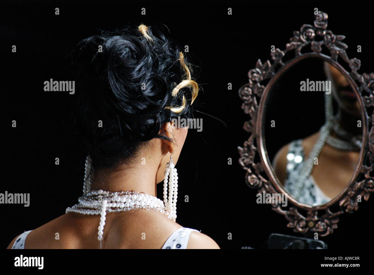 Woman looking over shoulder mirror hi-res stock photography and images ...