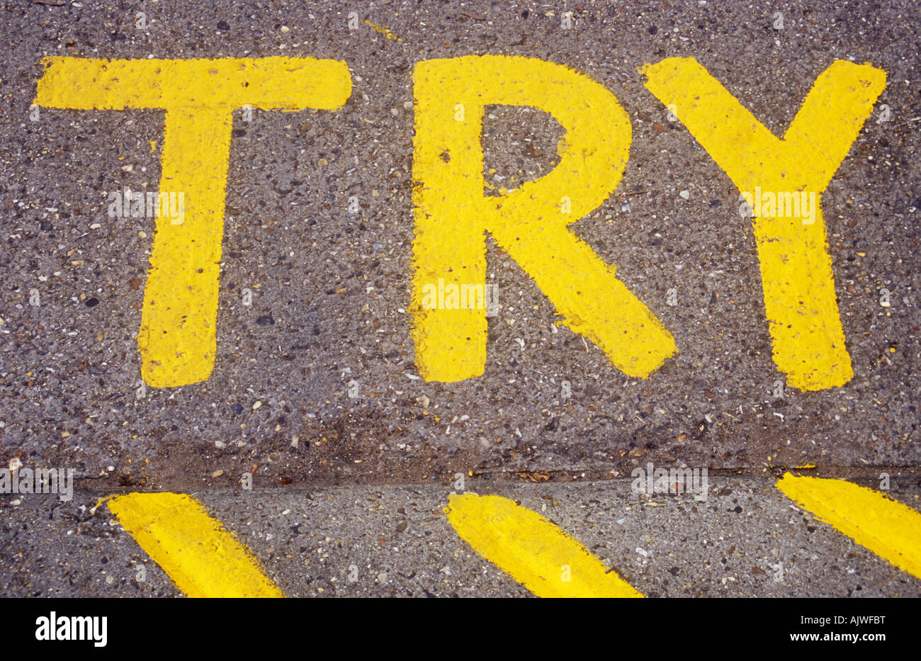 Yellow letters stating TRY and diagonal yellow hatched lines unevenly ...