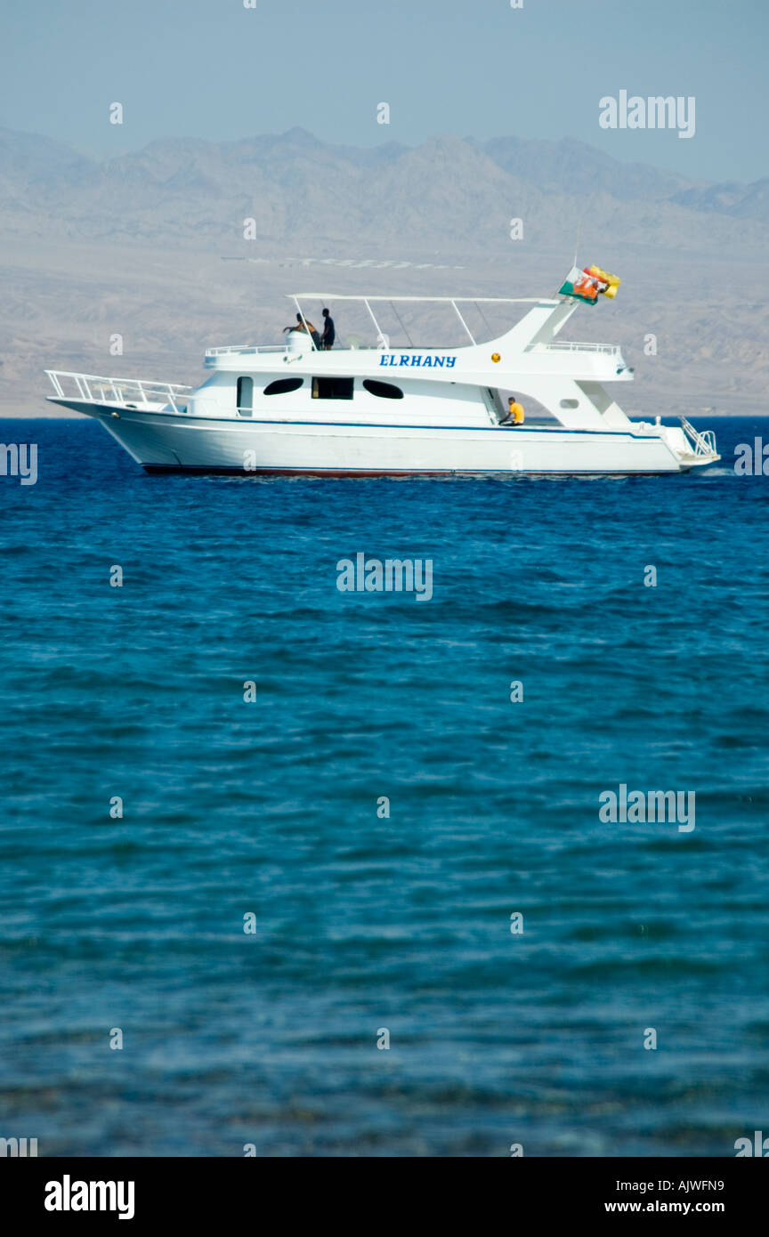 Vertical view of a white "liveaboard" dive boat powering across the Red ...