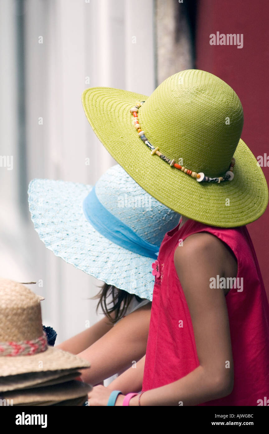two young girls wearing coloured hats Stock Photo - Alamy