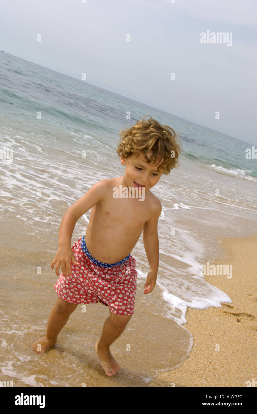 boy playing with ball on the beach Stock Photo - Alamy
