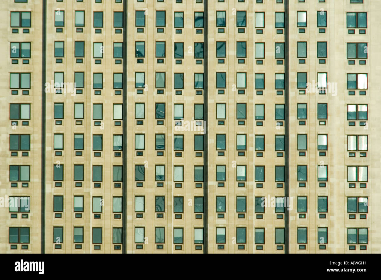 Horizontal close up of rows of symmetrical windows on a large office ...