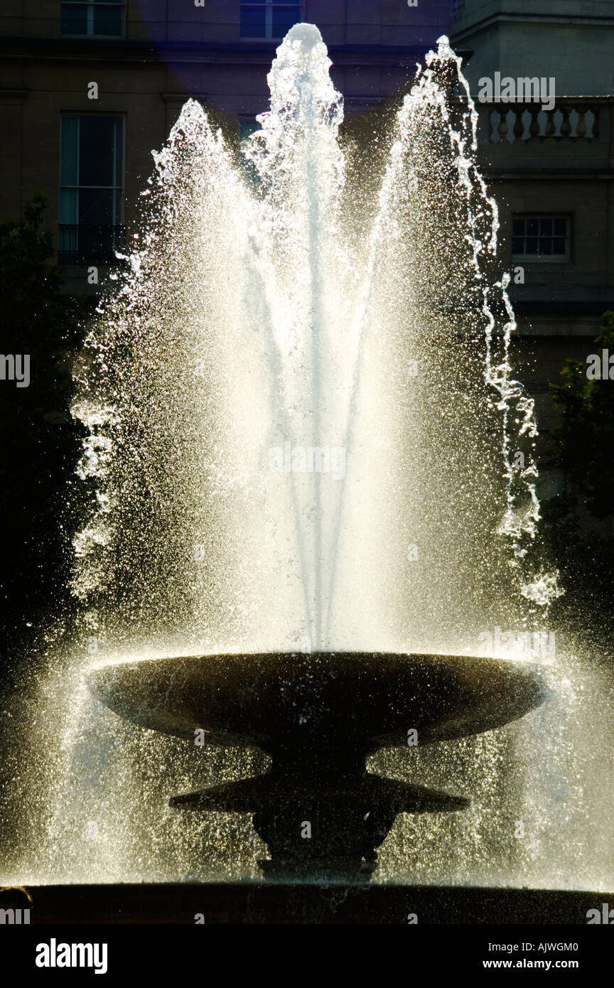 Vertical close up of the sun reflecting of the water gushing from ...