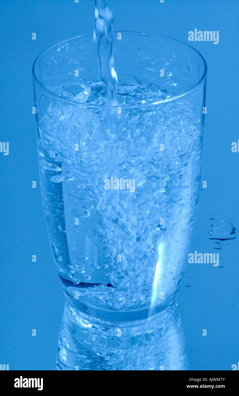 Water being poured into a glass Stock Photo - Alamy