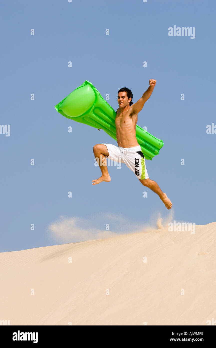 young man jumping at the beach Stock Photo - Alamy