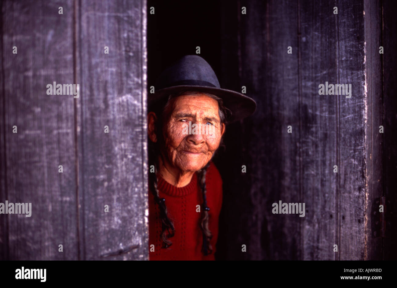 Old Peruvian lady grey hat and door red sweater Pisac Peru Stock Photo ...