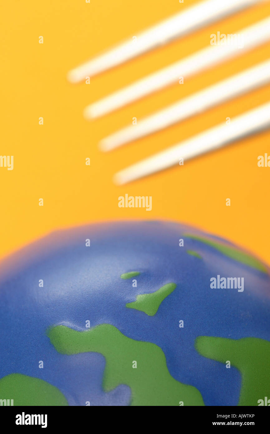 Feed World concept globe Earth food fork eat Stock Photo - Alamy