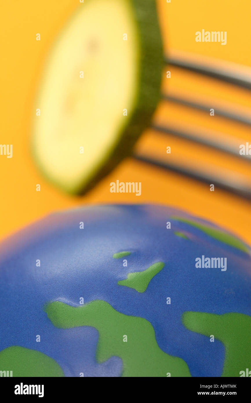 Feed the World concept globe Earth food fork Stock Photo - Alamy