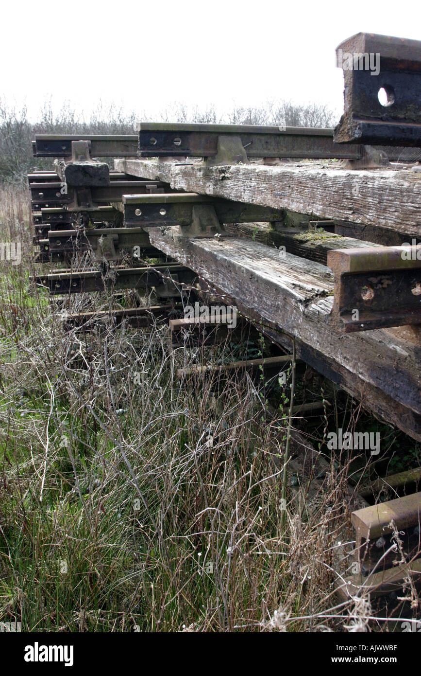 Stack of sections of railway track ready to be laid on prepared bed of ...