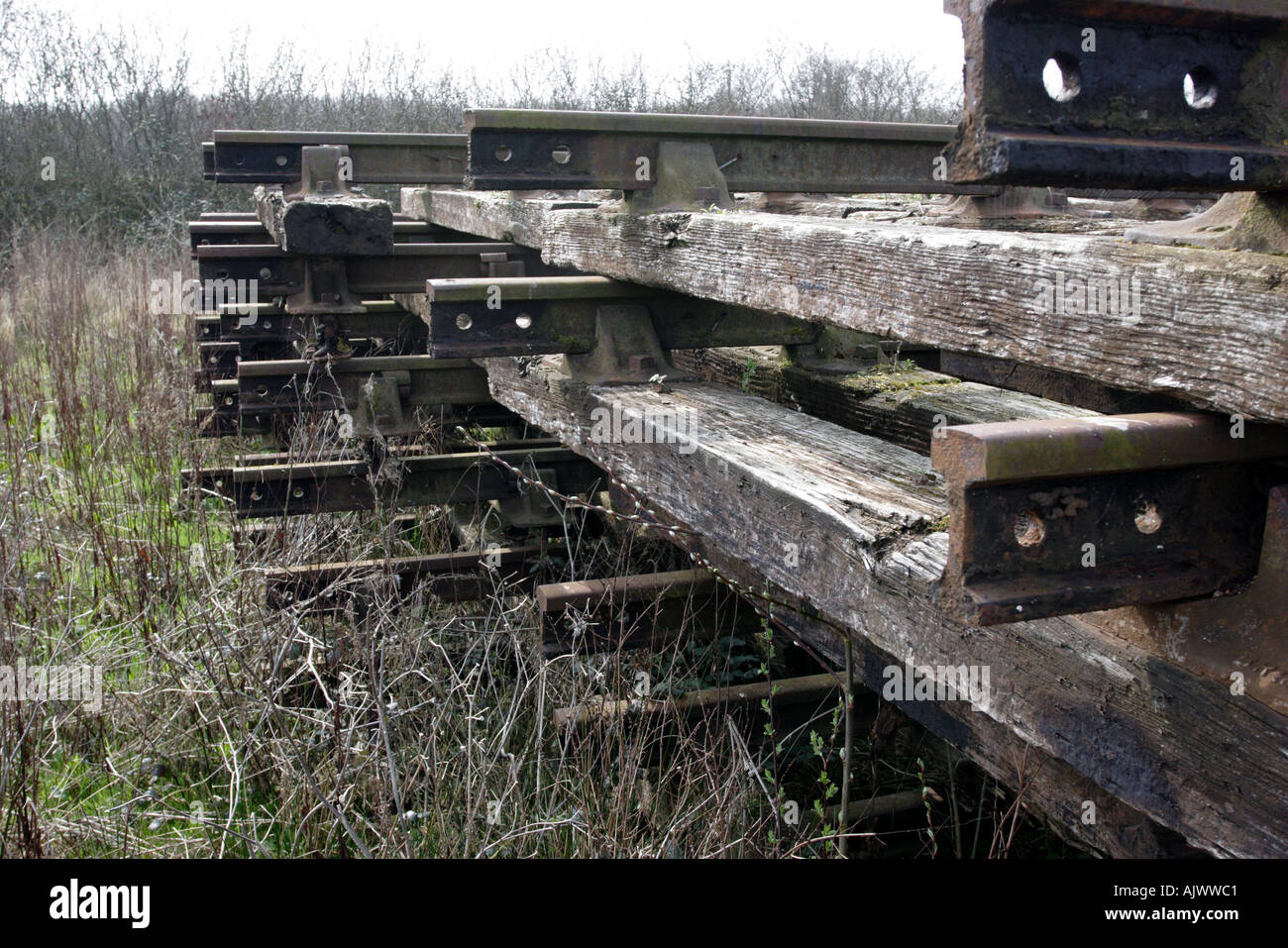 Stack of sections of railway track ready to be laid on prepared bed of ...