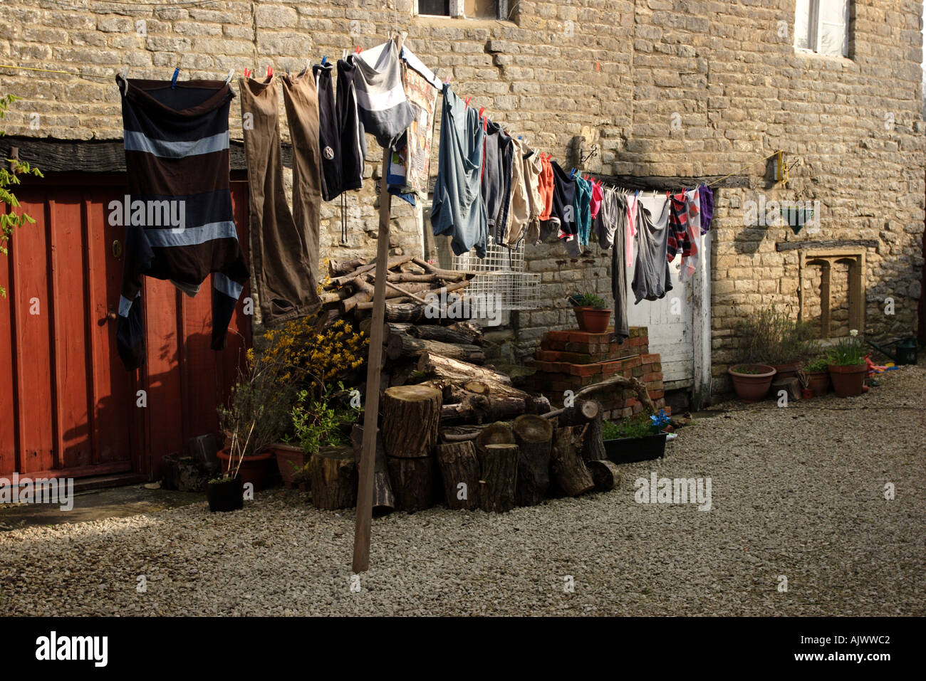 Washing line outside derelict cottage and stables Stock Photo - Alamy