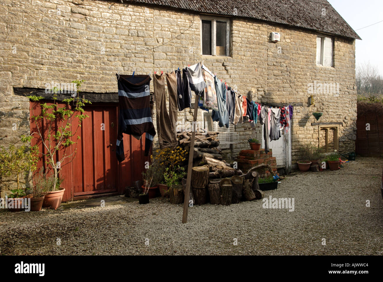 Washing line outside derelict cottage and stables Stock Photo - Alamy