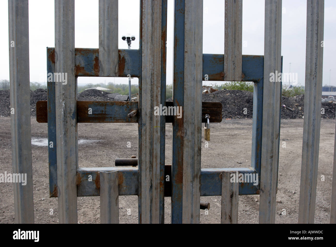 Locked gates denying access to derelict land Stock Photo - Alamy