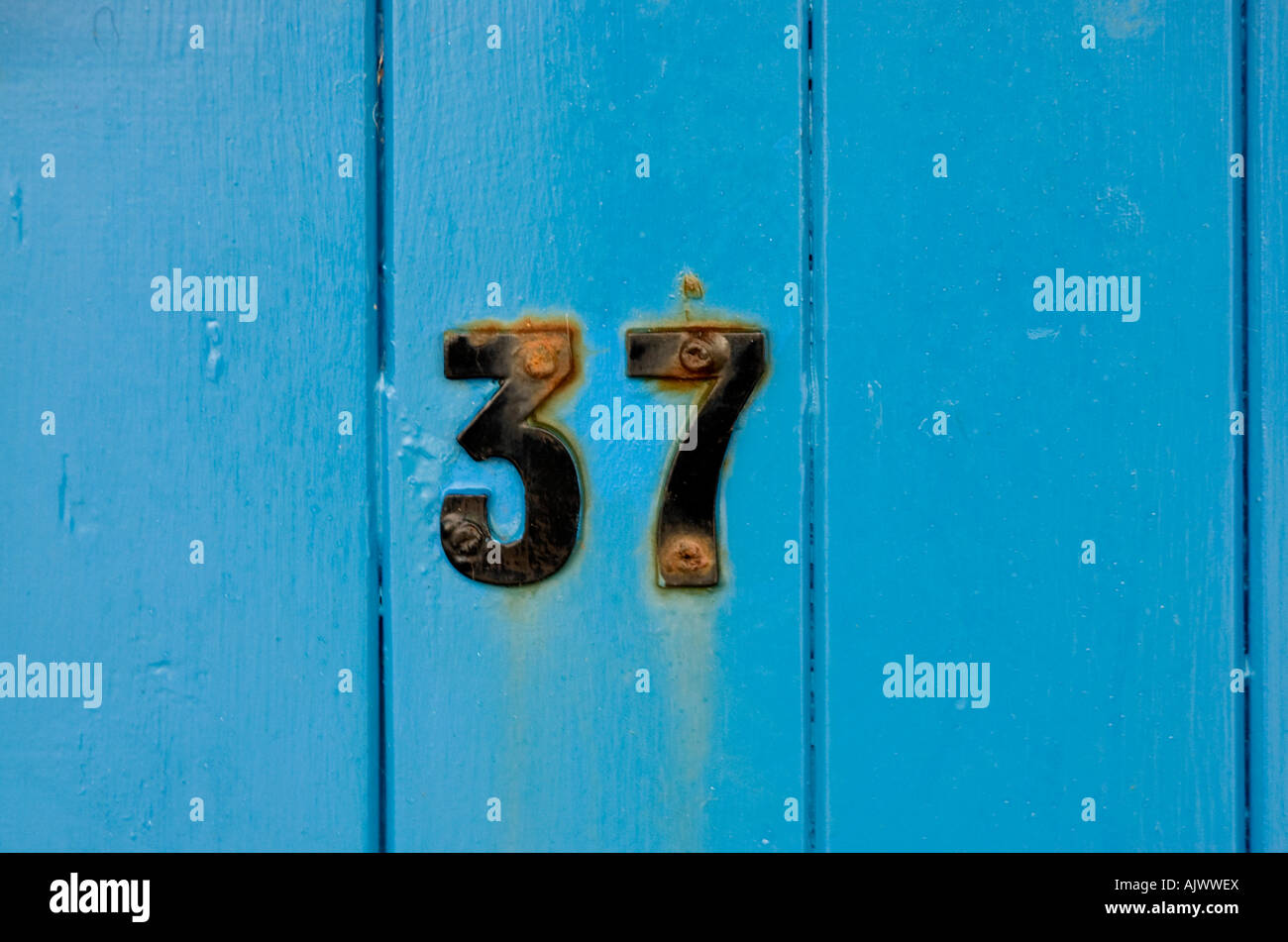Number 37 screwed onto blue wooden door Stock Photo - Alamy