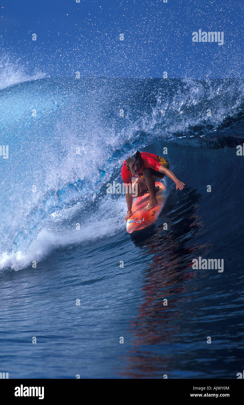 Male surfer on his board in the barrel of the wave in Tahiti Stock ...