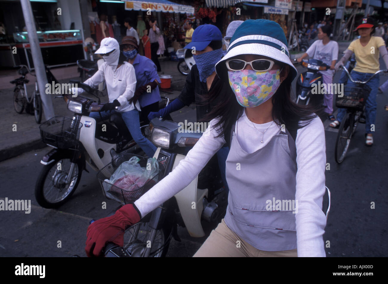 VIETNAM Scooter riders wear face masks against the pollution Ho Minh ...