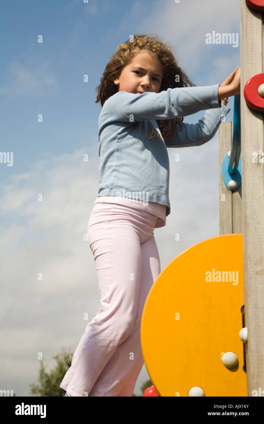 Child climbing a wooden structure at the playground Stock Photo - Alamy
