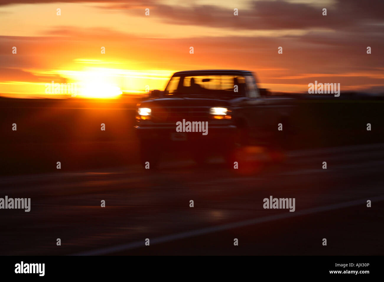 car passing by the setting sun Stock Photo - Alamy