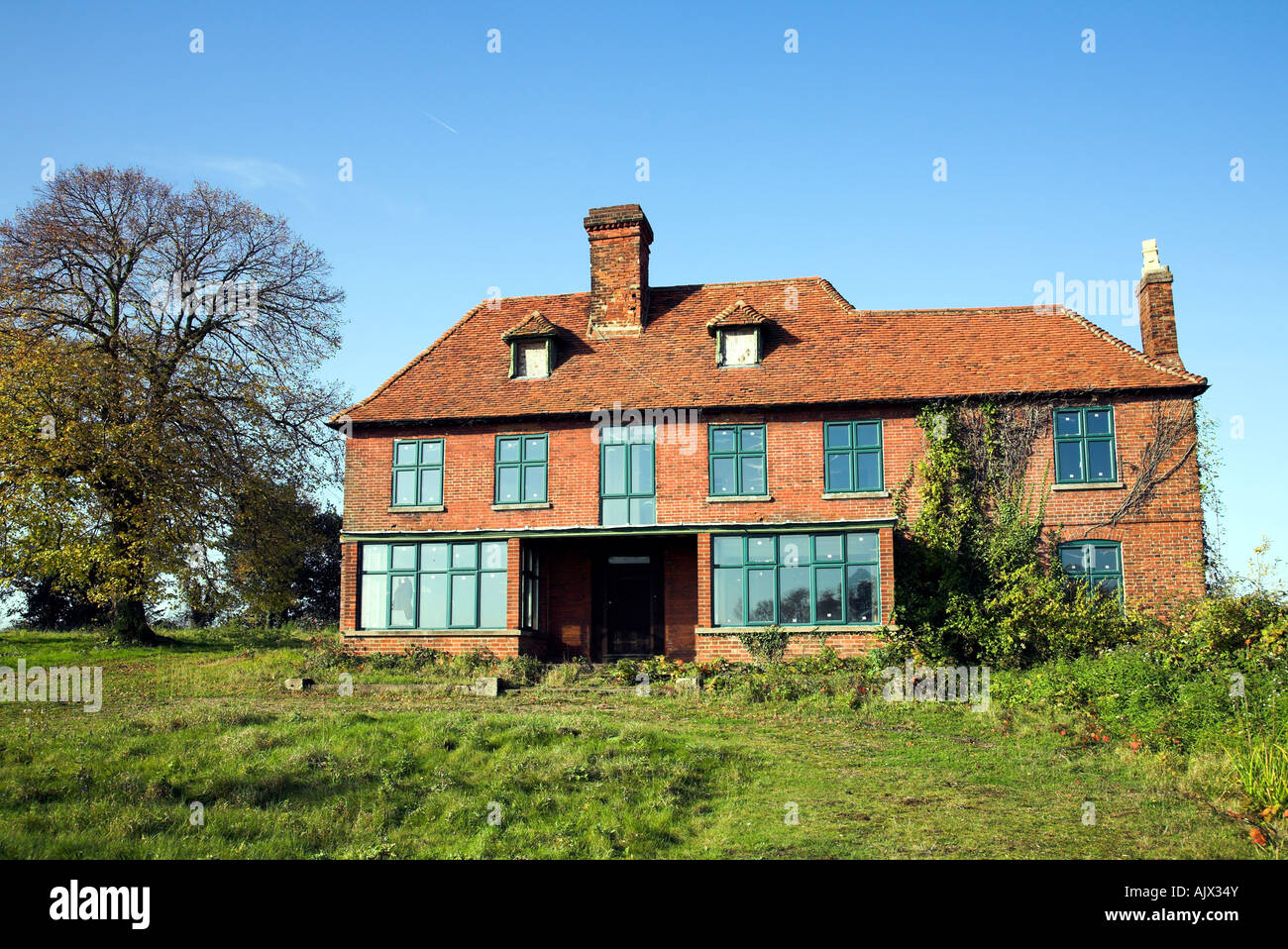An old abandoned house with overgrown garden Stock Photo - Alamy