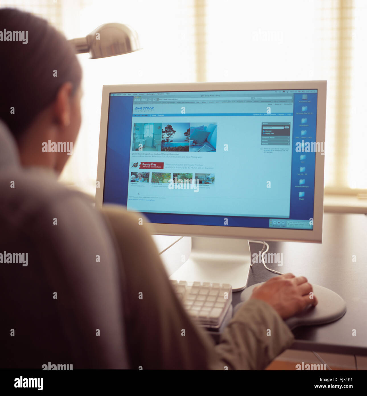 Back view of person looking at computer monitor Stock Photo - Alamy