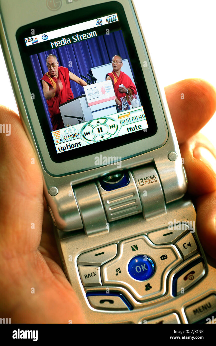 mobile or cell phone with Dali Lama TV broadcast Stock Photo - Alamy