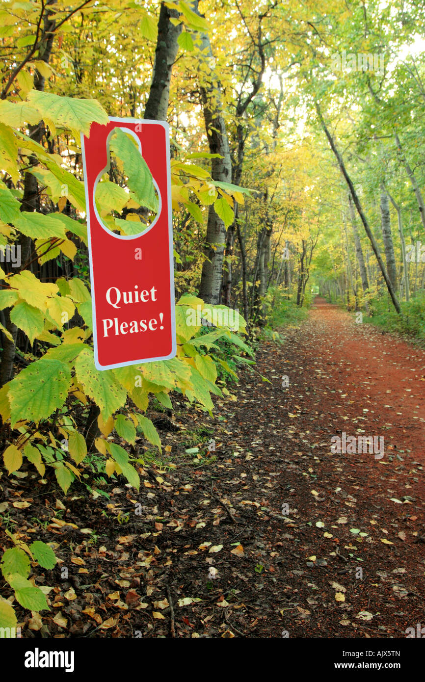 Walking trail with quiet please sign Stock Photo - Alamy