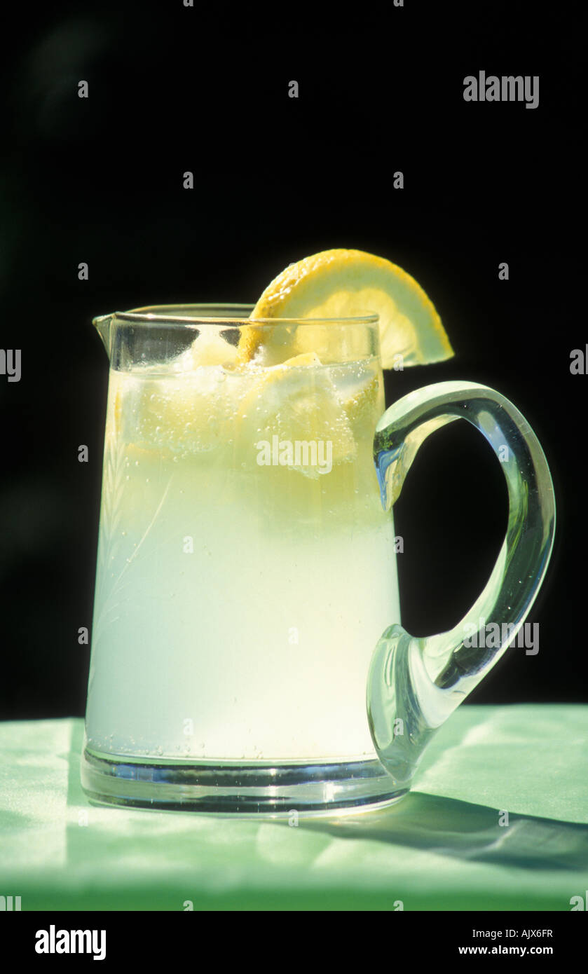 Jug filled with lemonade and garnished with slice of lemon Stock Photo ...
