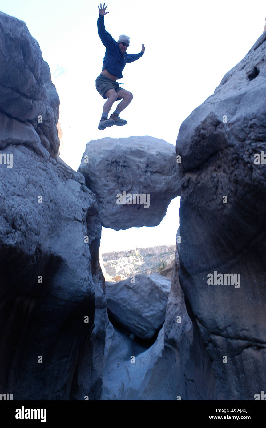 man jumping above rock Stock Photo - Alamy