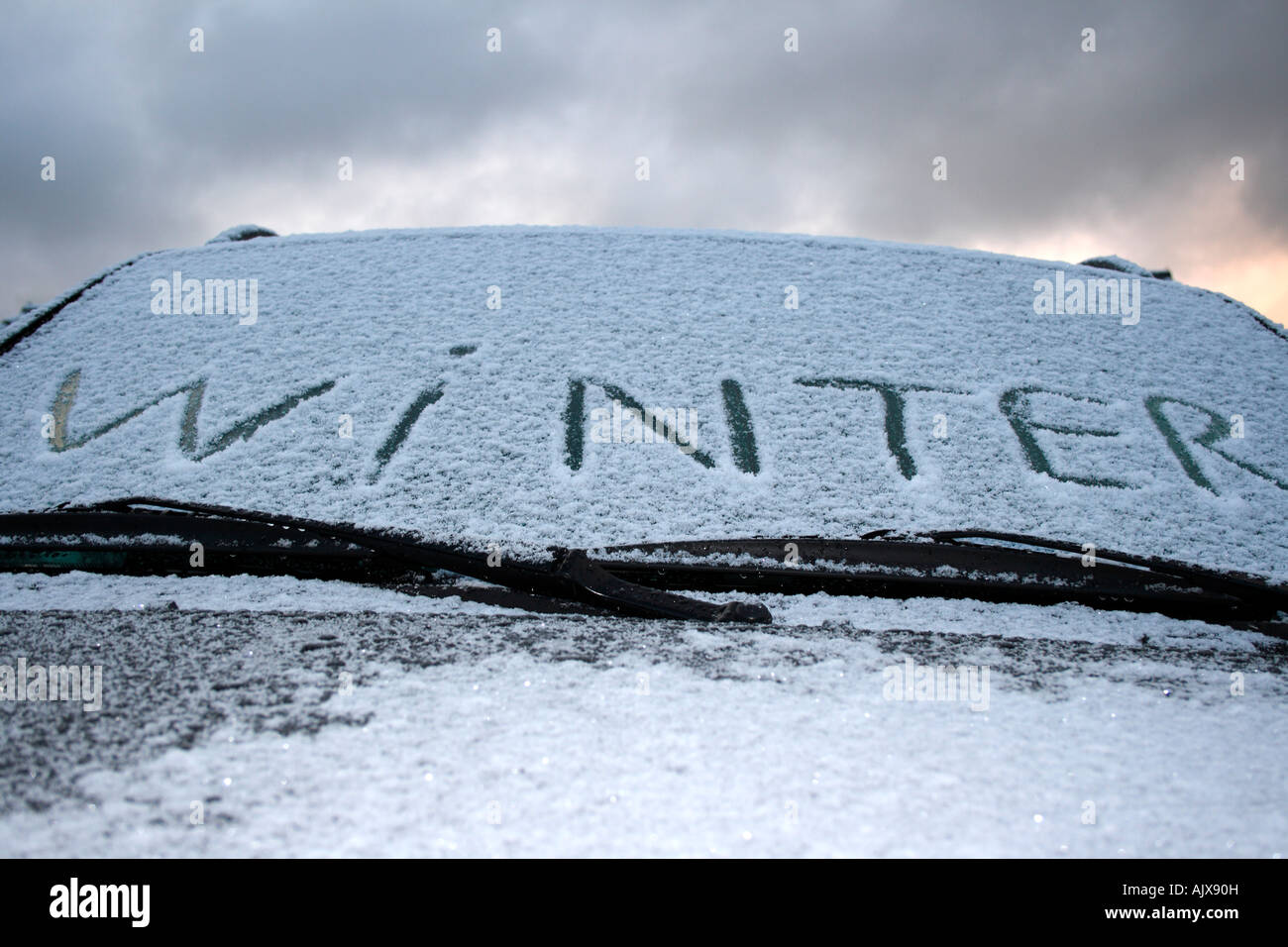 the word winter written in snow on windshield of a car. Photo by Willy ...