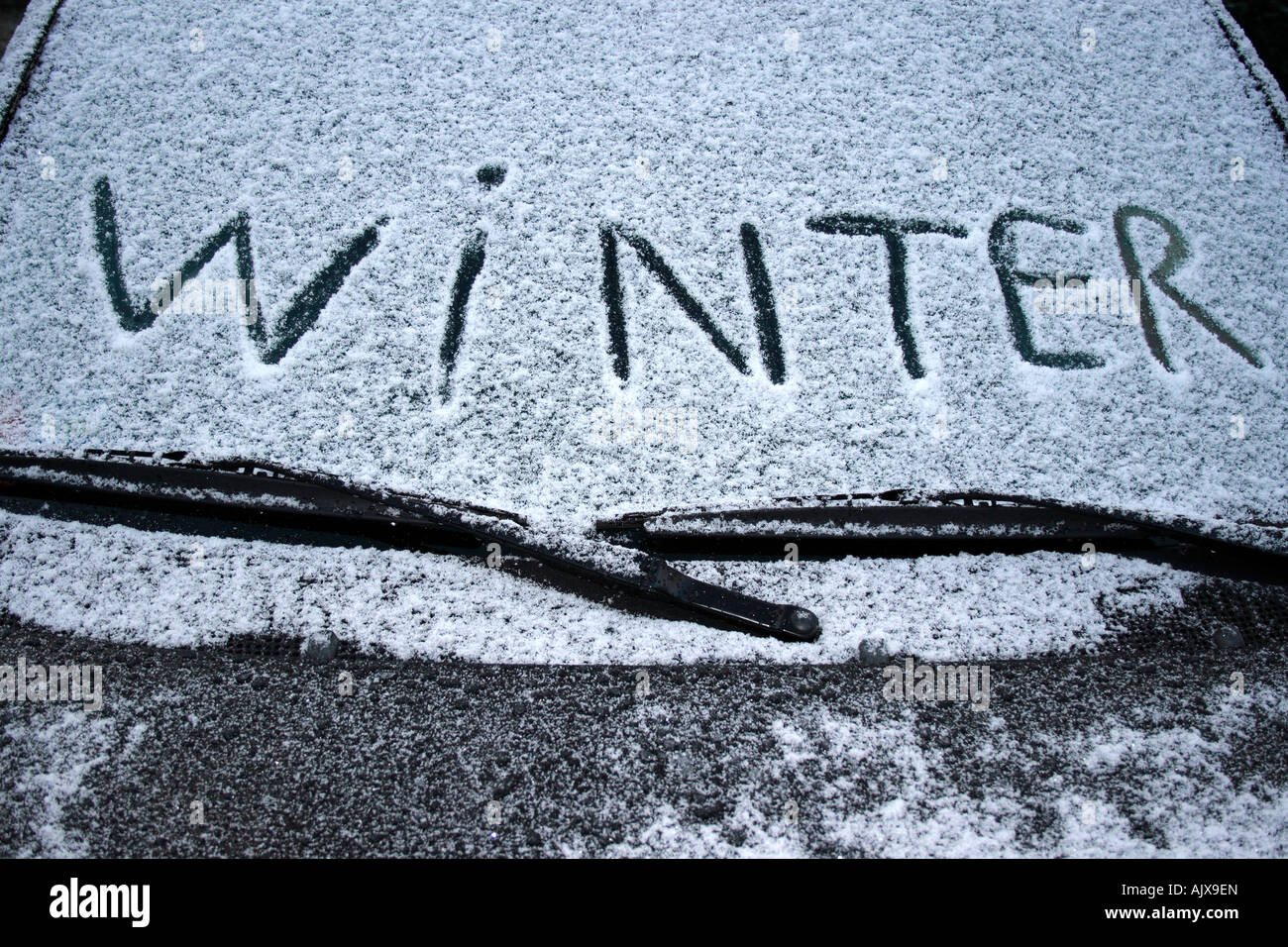 the word winter written in snow on windshield of a car. Photo by Willy ...