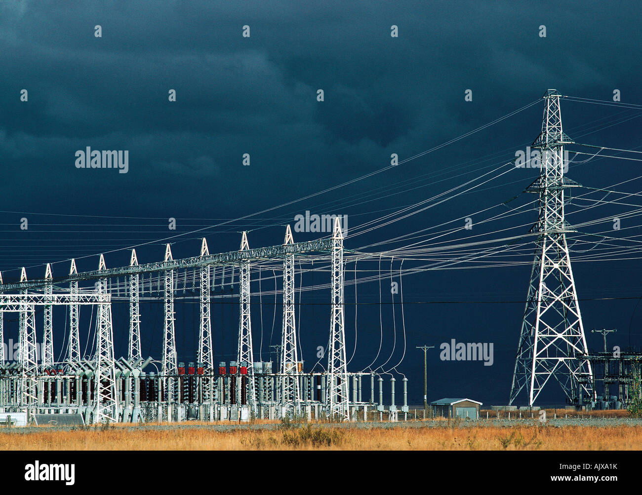 Electricity pylons and power cables against dark stormy sky. Australia ...