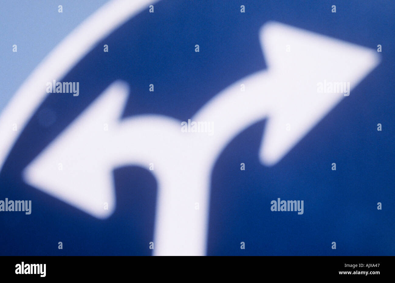 Road sign directing traffic to left or right Stock Photo - Alamy