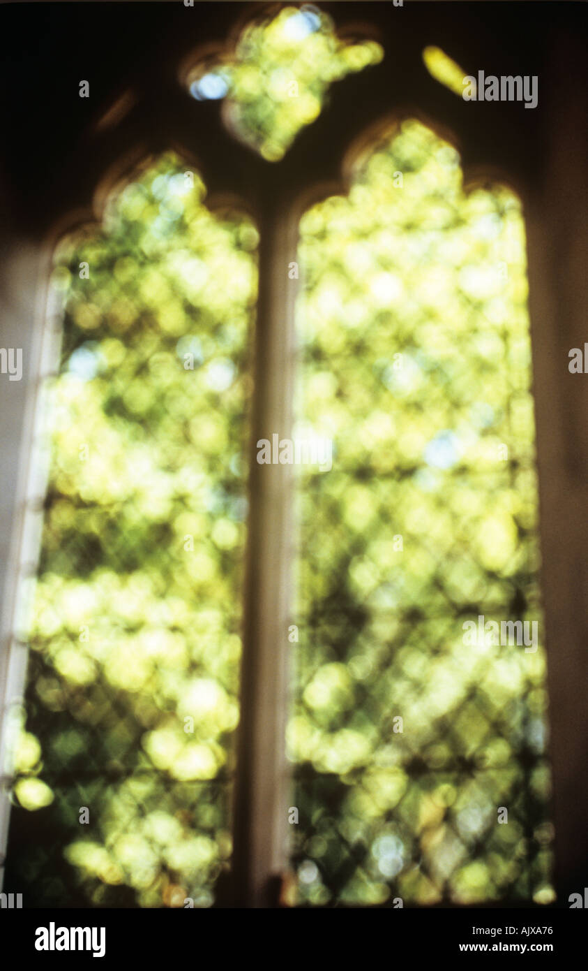 Clear leaded church window with spring leaves visible outside England ...