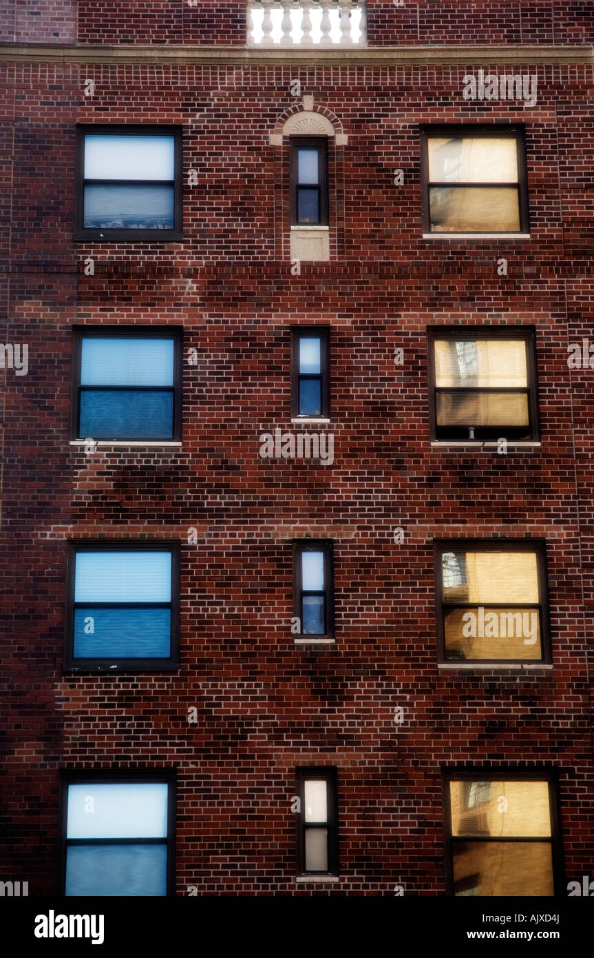 vertical brick building in NYC with colorful windows Stock Photo - Alamy