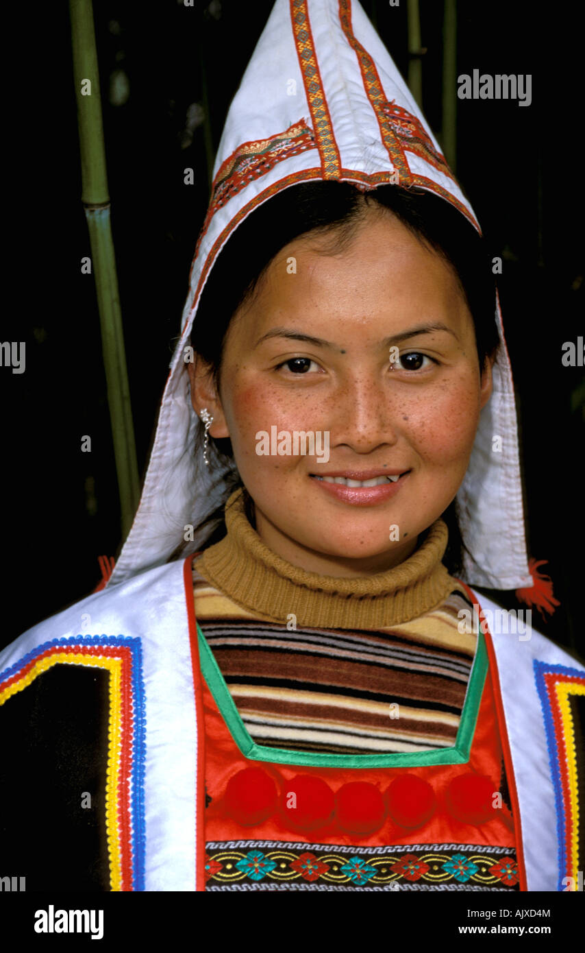 Asia, China, Yunnan Province, Kunming. Young Jinuo woman in traditional ...