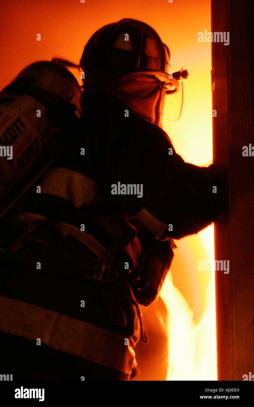 A Fire fighter enterning a room of fire Stock Photo - Alamy