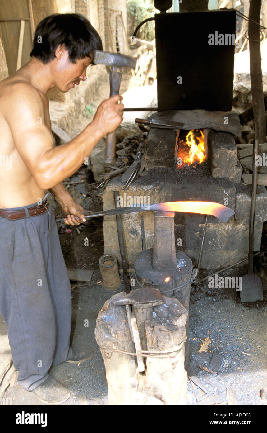 Asia, China, Yunnan Province, Lincang Region, Nansan Town. Blacksmith ...