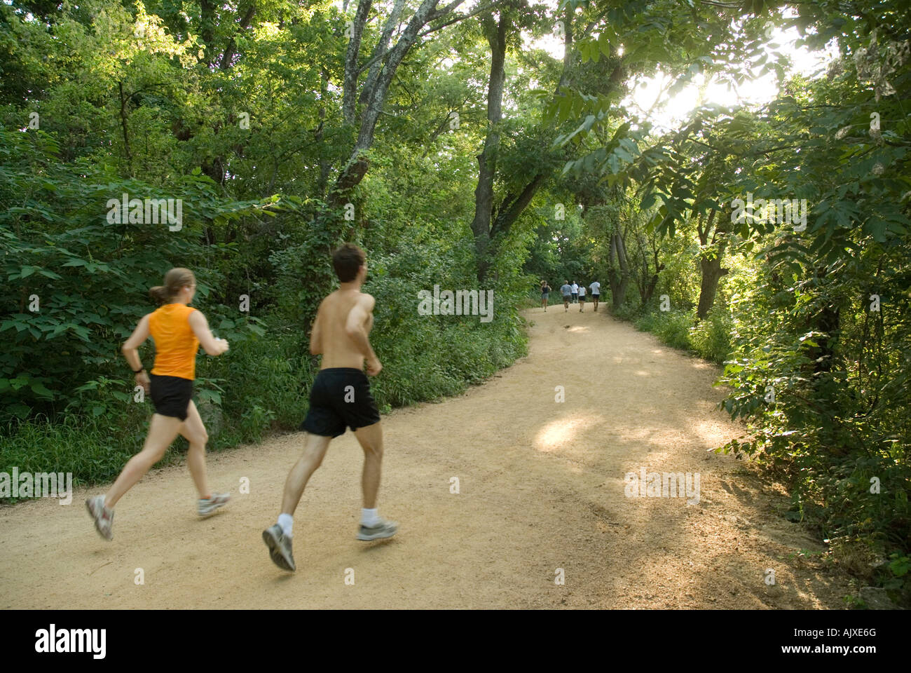 couple running on trail Stock Photo - Alamy
