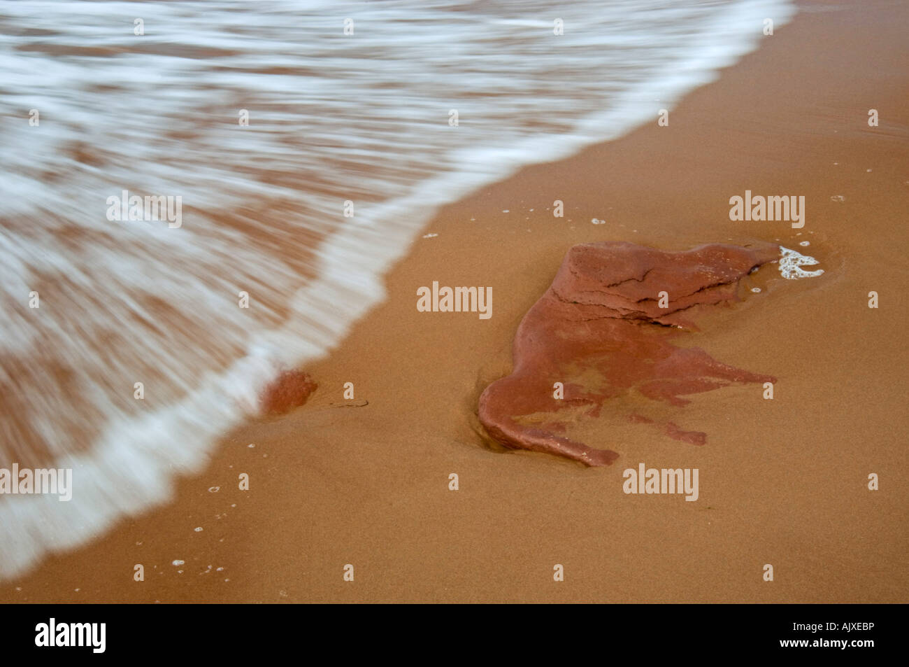 Red rocks, sand and surf along Campbell's Cove beach, Campbell's Cove ...