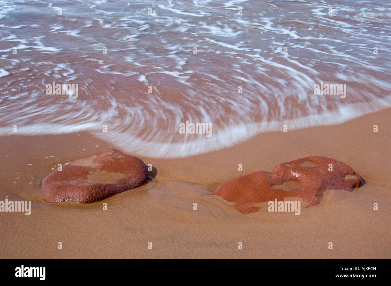 Red rocks, sand and surf along Campbell's Cove beach, Campbell's Cove ...