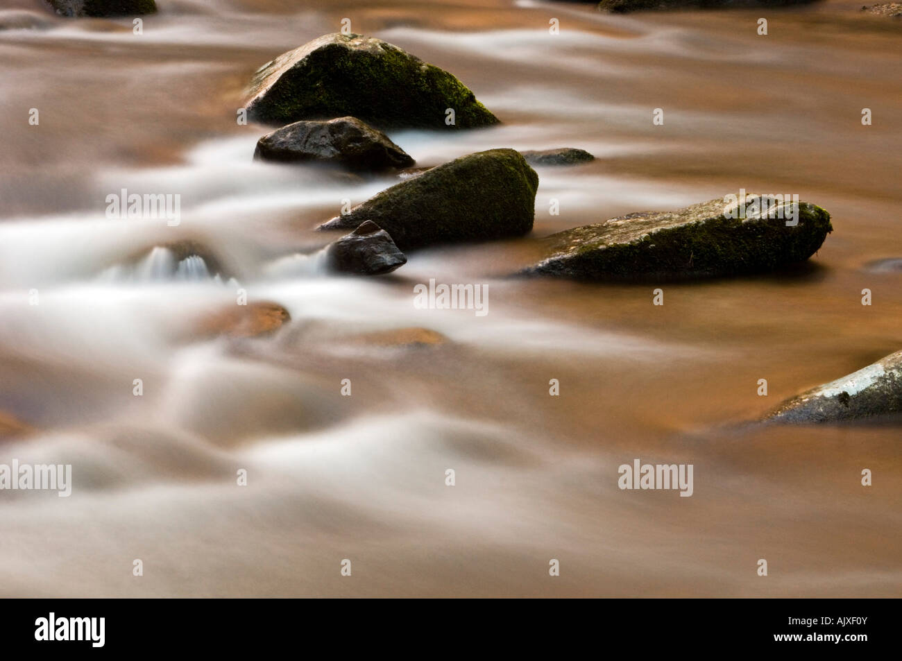 Boulders and rapids with evening sky reflections in the Little River ...